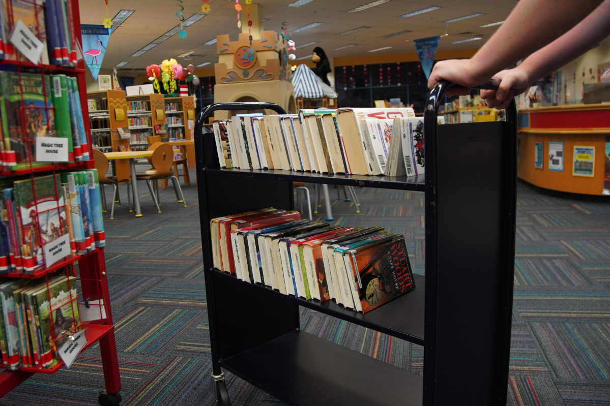 photos by luis santana times a librarian moves a shelving cart to the ...