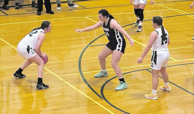 Mike Mandell/Morning Sentinel Richmond’s Izzy Stewart, center, defends ...